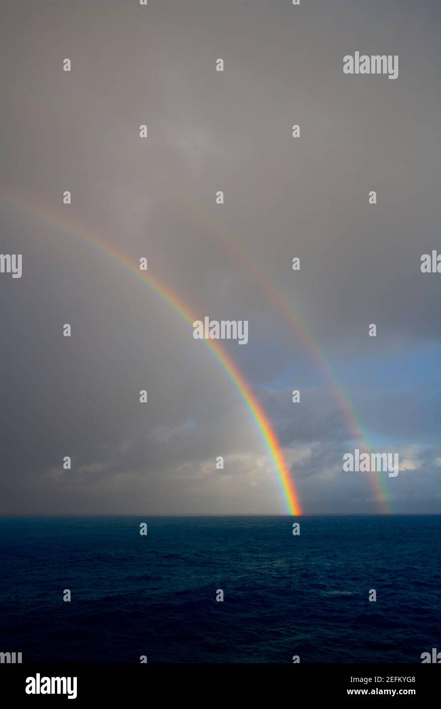 Double rainbow appears over the Pacific Ocean in the dusk at Big Island ...