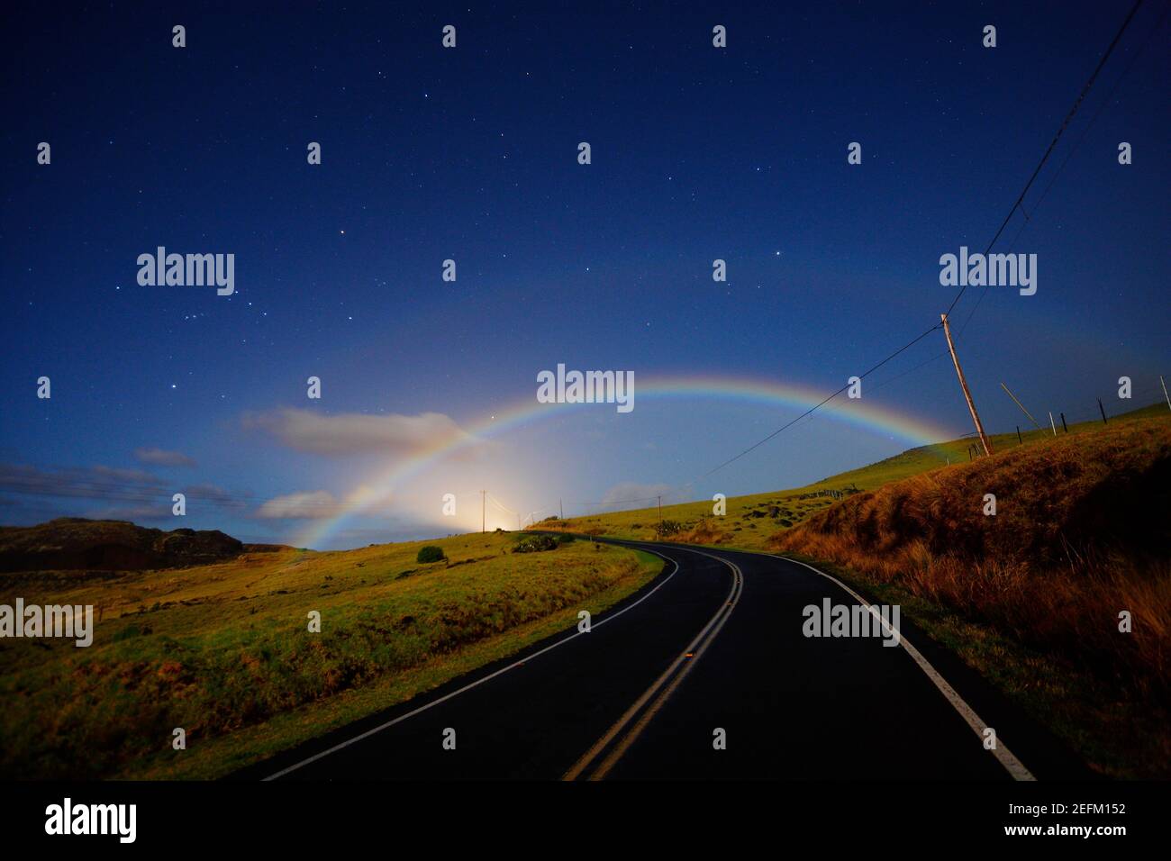 Double Moonbow appears over high plateau road at moon night Hawaii USA ...