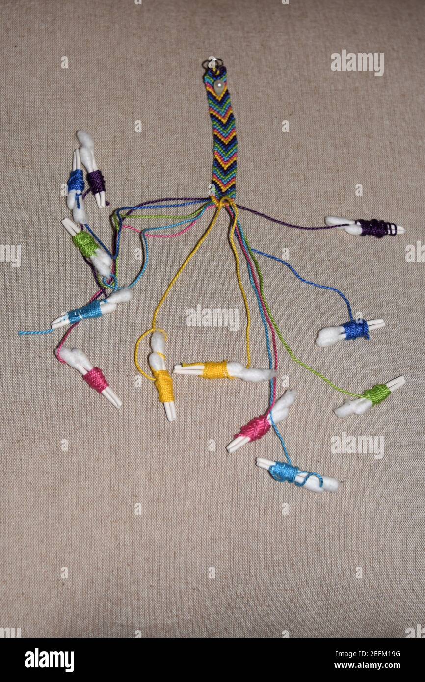 DIY craft project of weaving thread into a friendship bracelet with ...