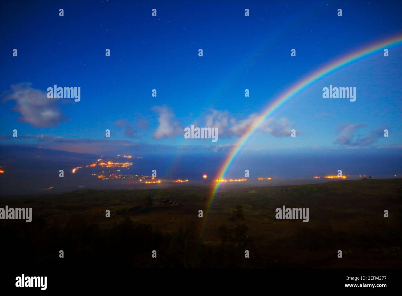 Moonbow appears over the Kohala Coast in the night at Big Island Hawaii ...