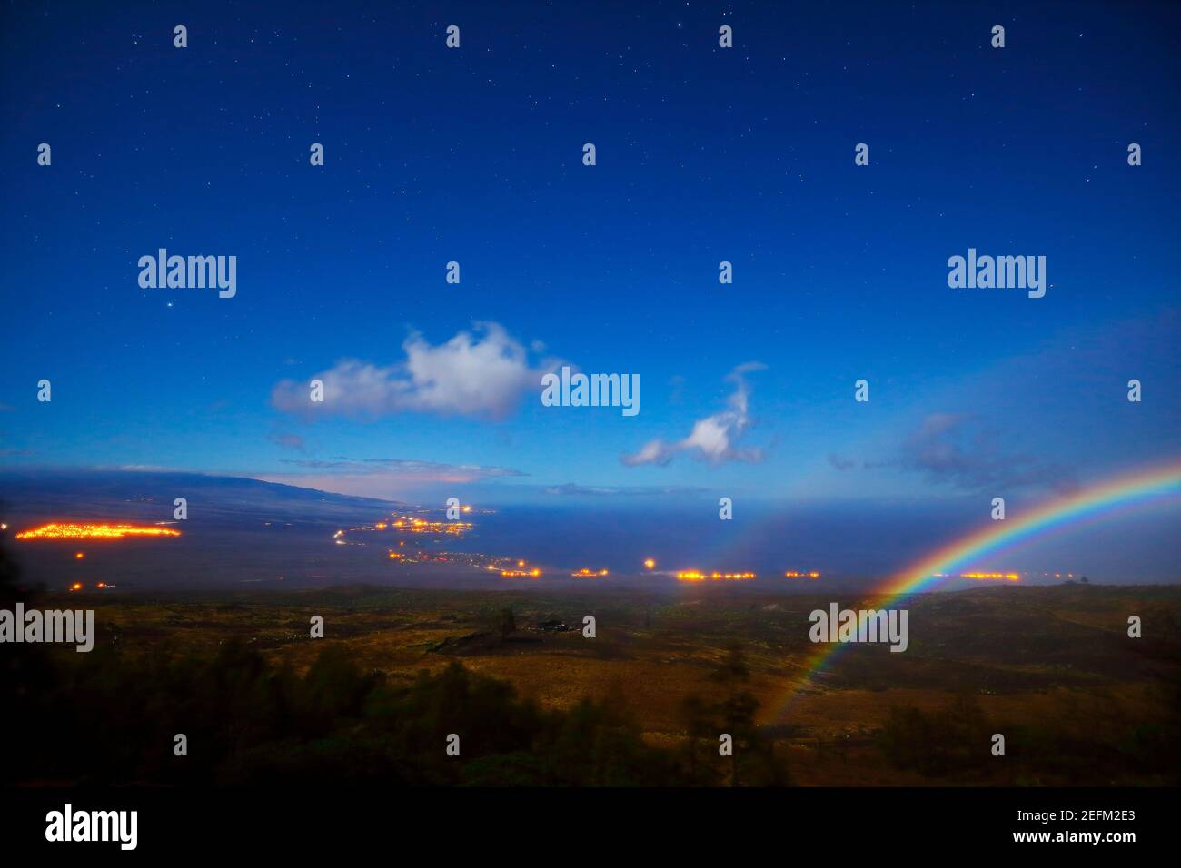 Moonbow appears over the Kohala Coast in the night at Big Island Hawaii ...