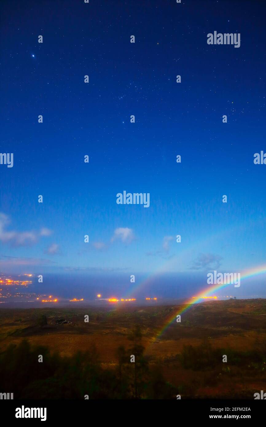Moonbow appears over the Kohala Coast in the night at Big Island Hawaii ...