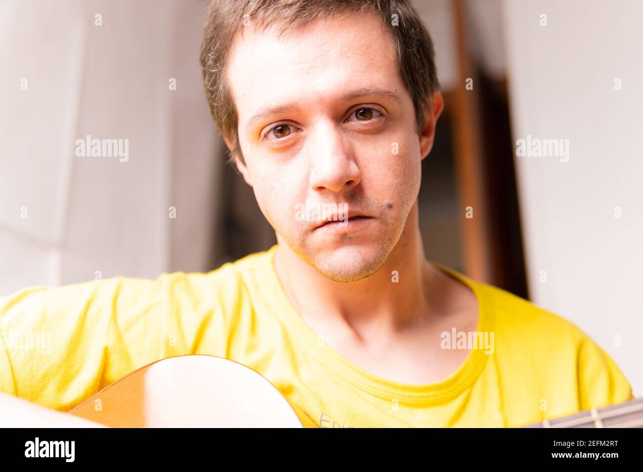 Young middle-aged man playing Spanish guitar Stock Photo - Alamy