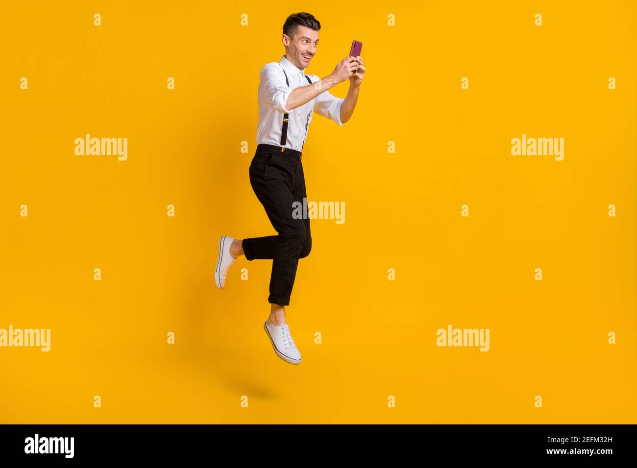 Full length body size view of nice skinny cheerful guy jumping using ...