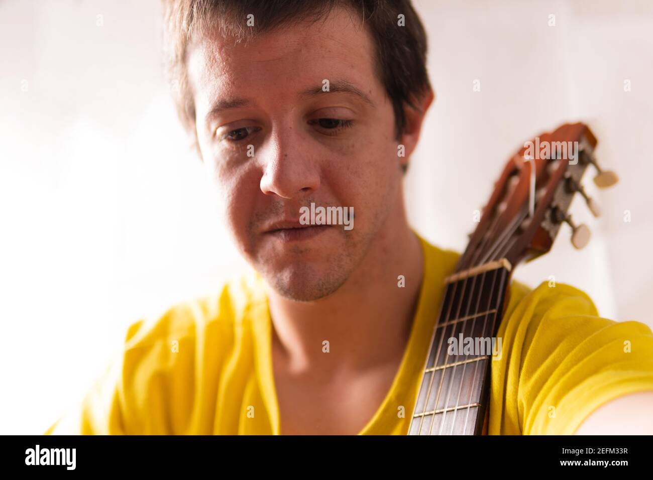 Young middle-aged man playing Spanish guitar Stock Photo - Alamy