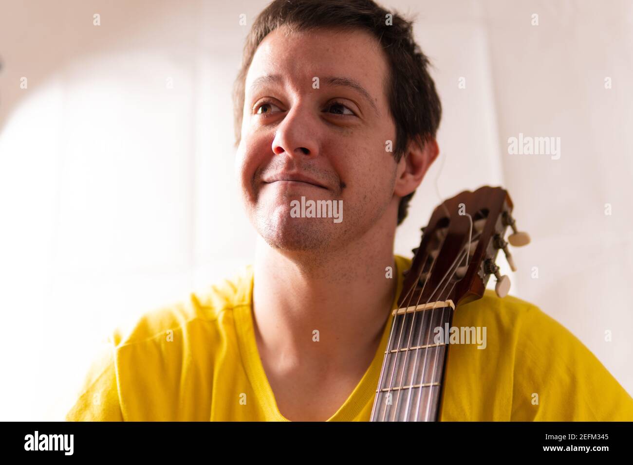 Young middle-aged man playing Spanish guitar Stock Photo - Alamy