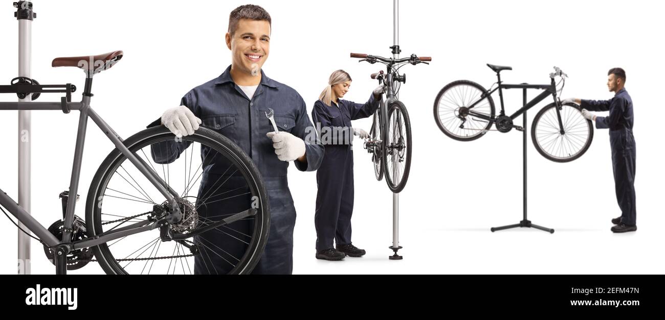 Team of mechanics working in a bicycle repair shop isolated on white ...