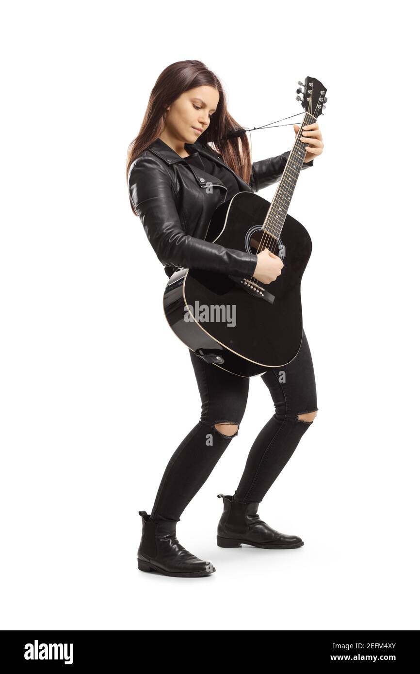Young female rocker playing an acoustic guitar isolated on white ...