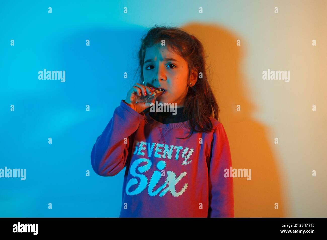 Portrait of a child eating a snack high protein bar on colorful ...