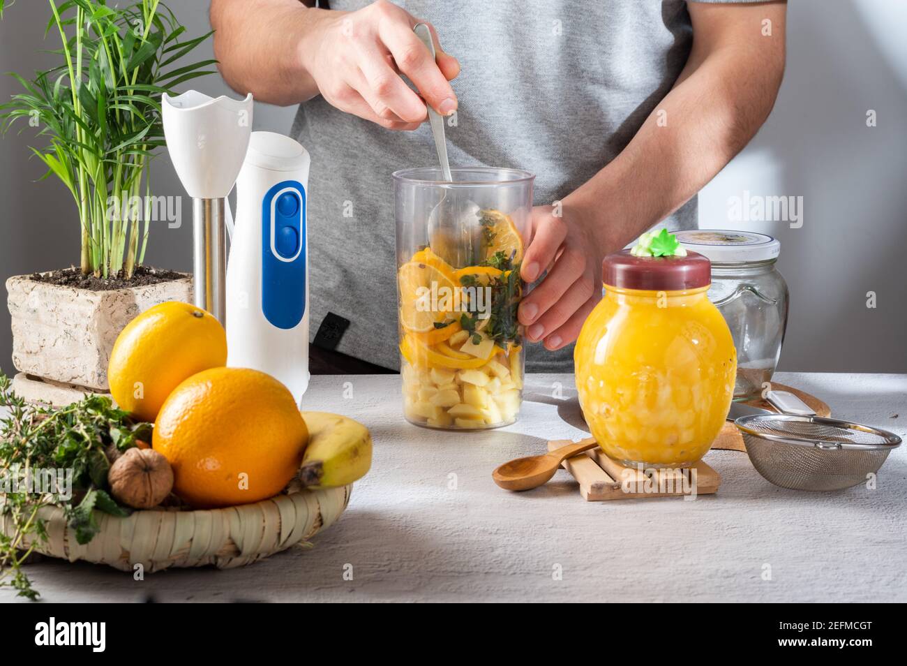 The cook mixes the food with a spoon. The bartender mixes the food for ...