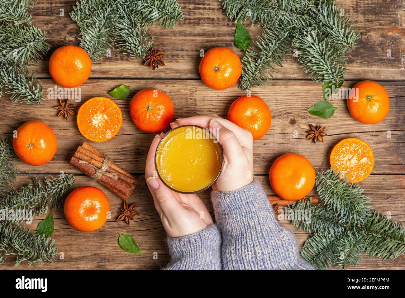 The woman's hands hold sweet jelly made from fresh tangerines. Ripe ...