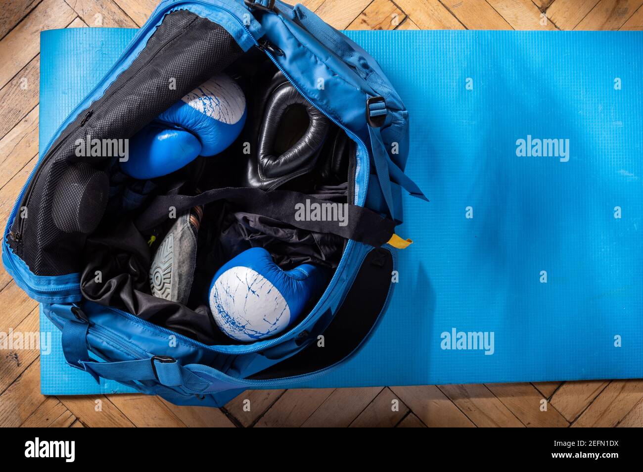 Boxing equipment in a gym bag. Blue bag on a blue background. Top Stock ...