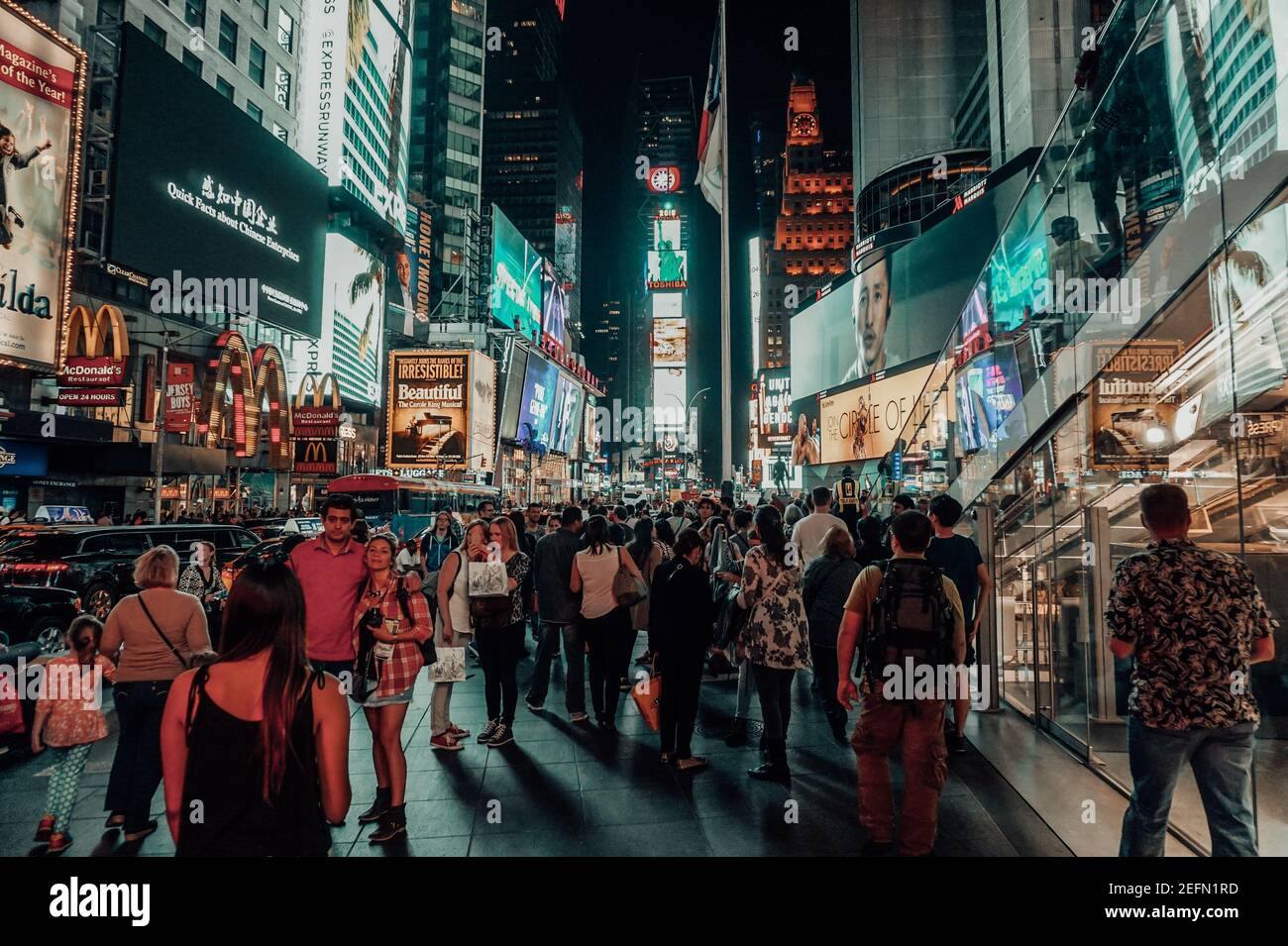 People walking in Times Square at night an iconic street of New York ...
