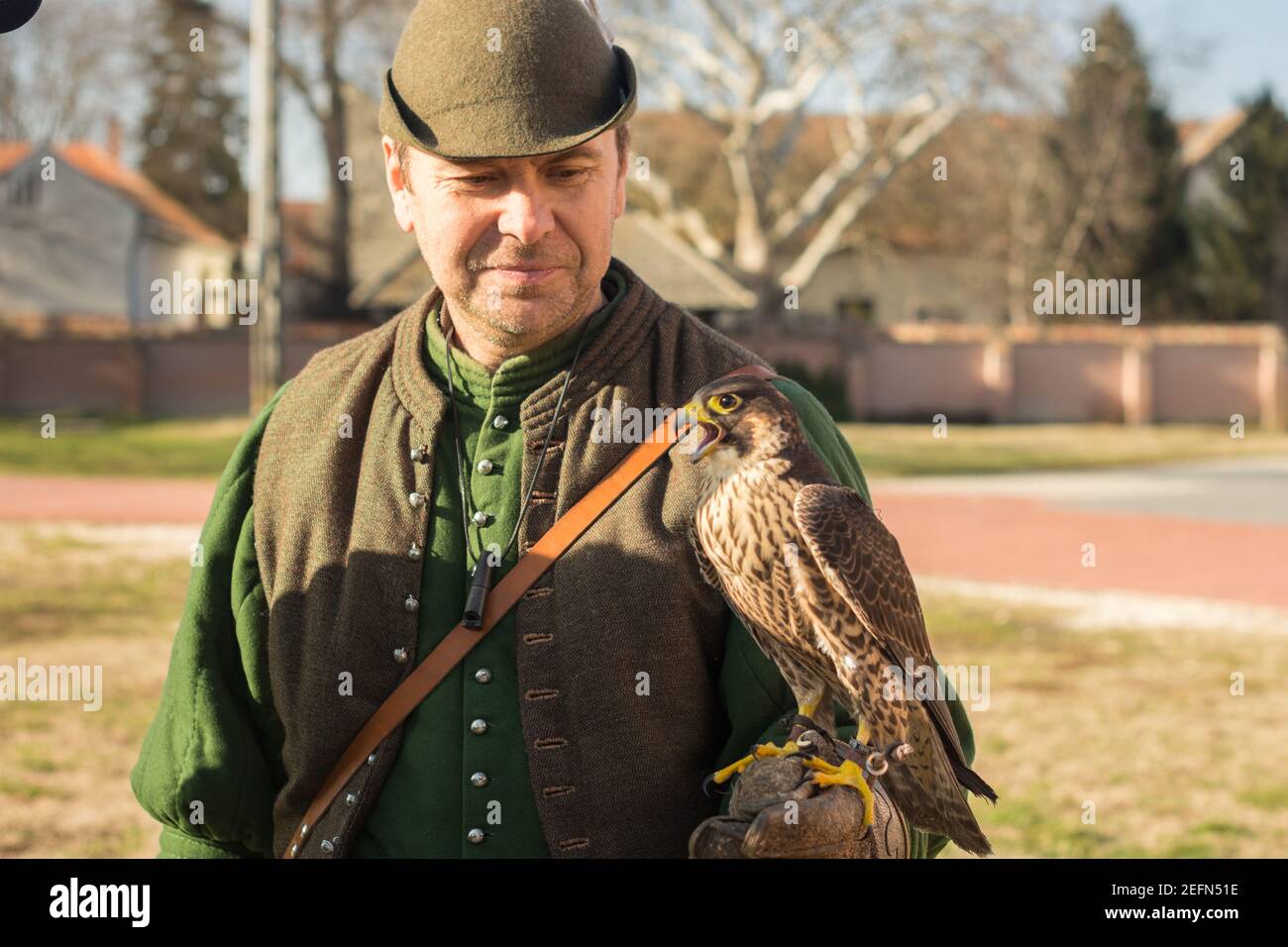 Male hunter with bird of prey on hand Stock Photo - Alamy