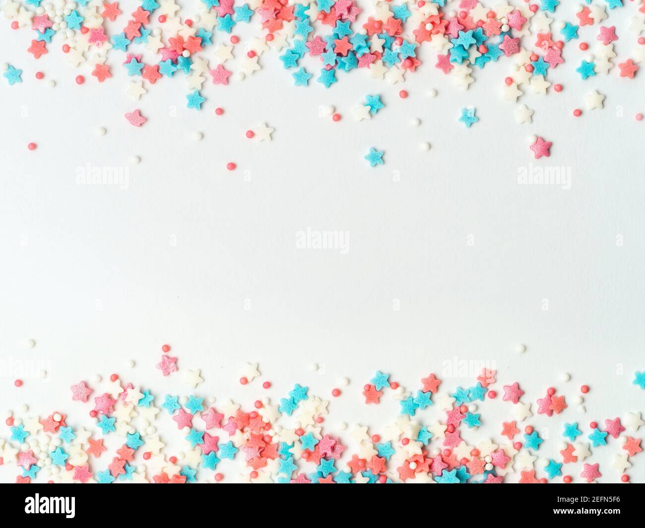 Festive border frame of colorful pastel sprinkles on white background ...