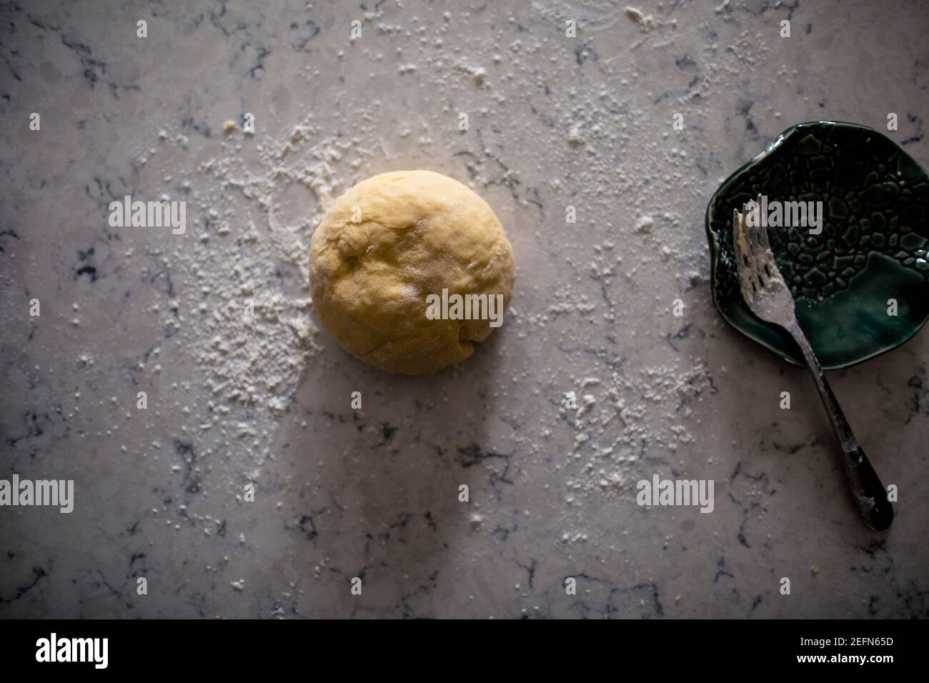 Above shot of dough ball resting on the kitchen counter with fork Stock ...
