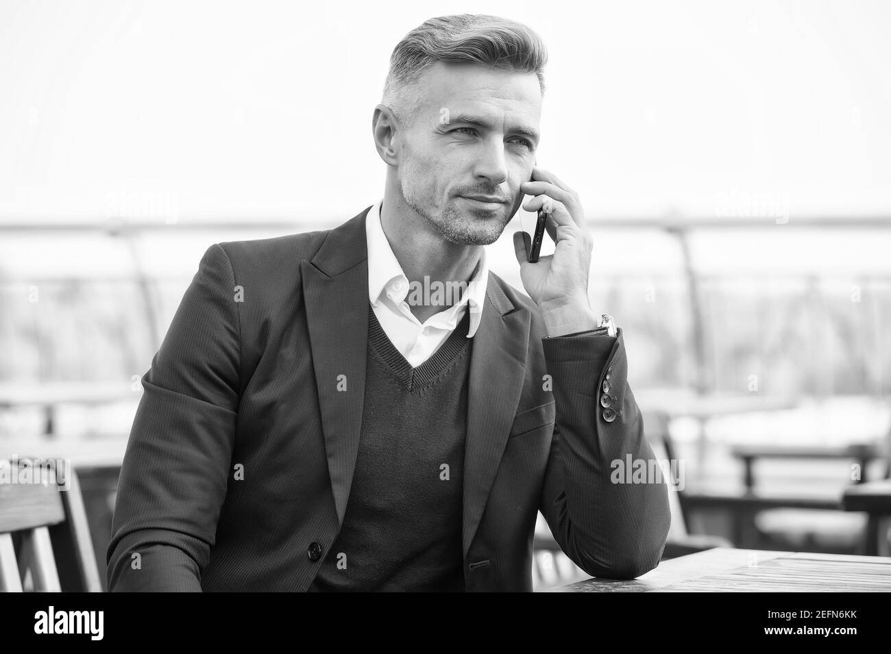 Man in suit phone serious Black and White Stock Photos & Images - Alamy