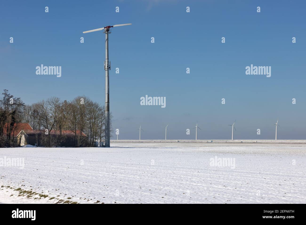 Dutch farmland covered by snow with farmhouse and wind turbine Stock ...
