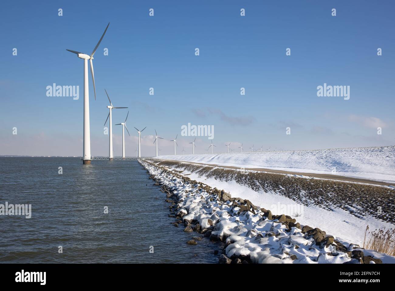 Row offshore windturbines along Ductch coast in winter with snow Stock ...