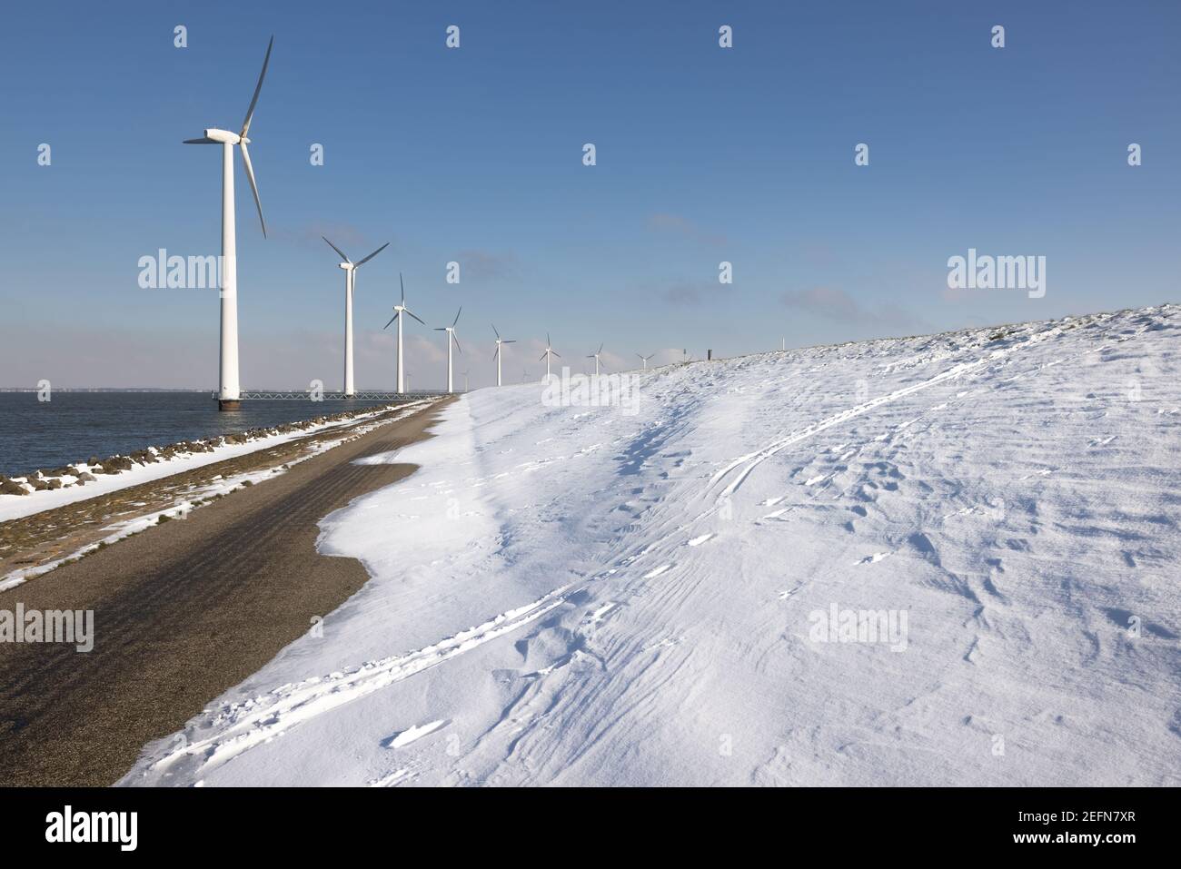 Row offshore windturbines along Ductch coast in winter with snow Stock ...