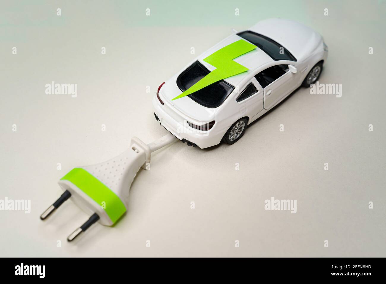 Toy car and electrical plug. Electric car and green car concept Stock ...