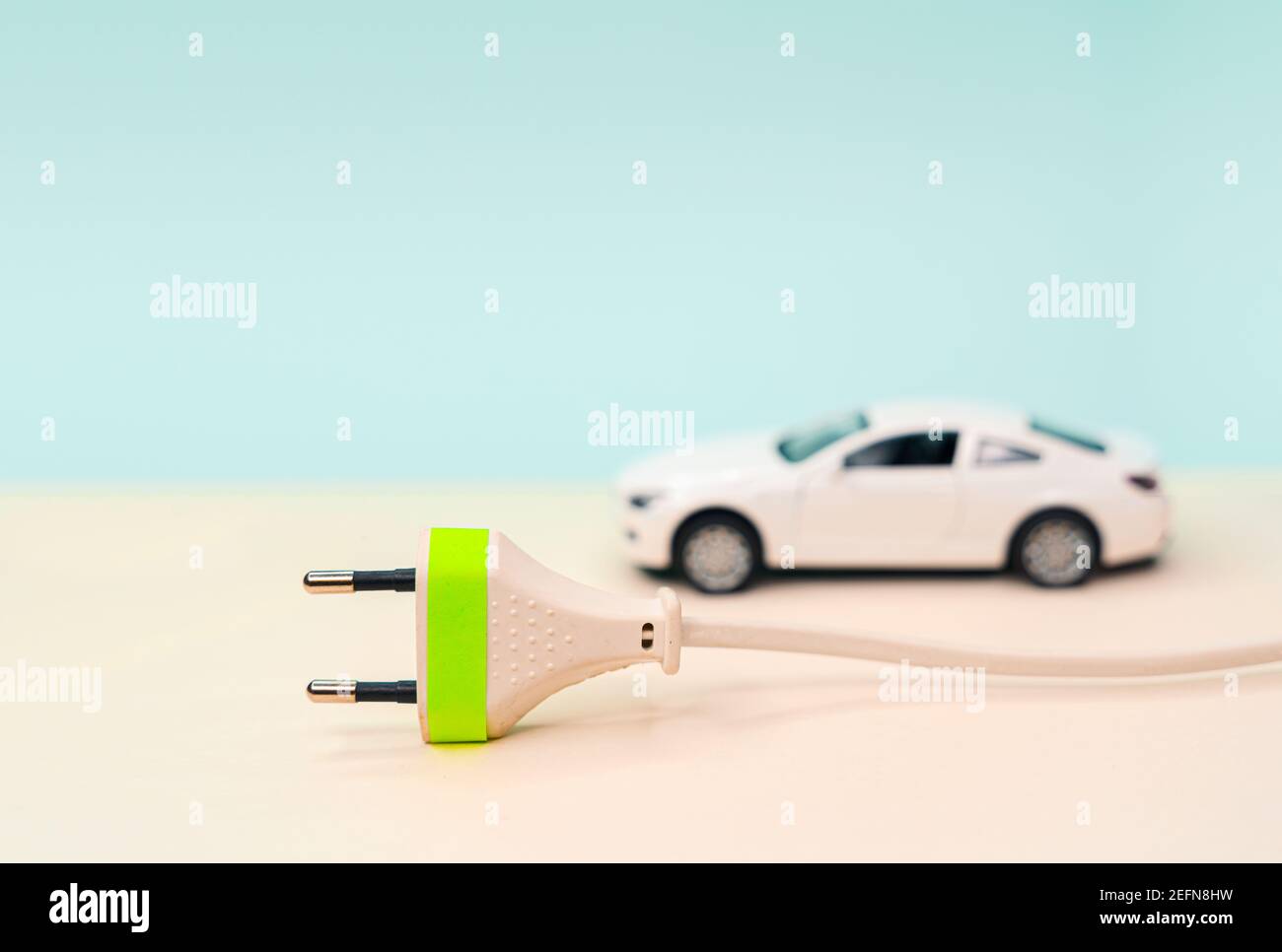 Toy car and electrical plug. Electric car and green car concept Stock ...