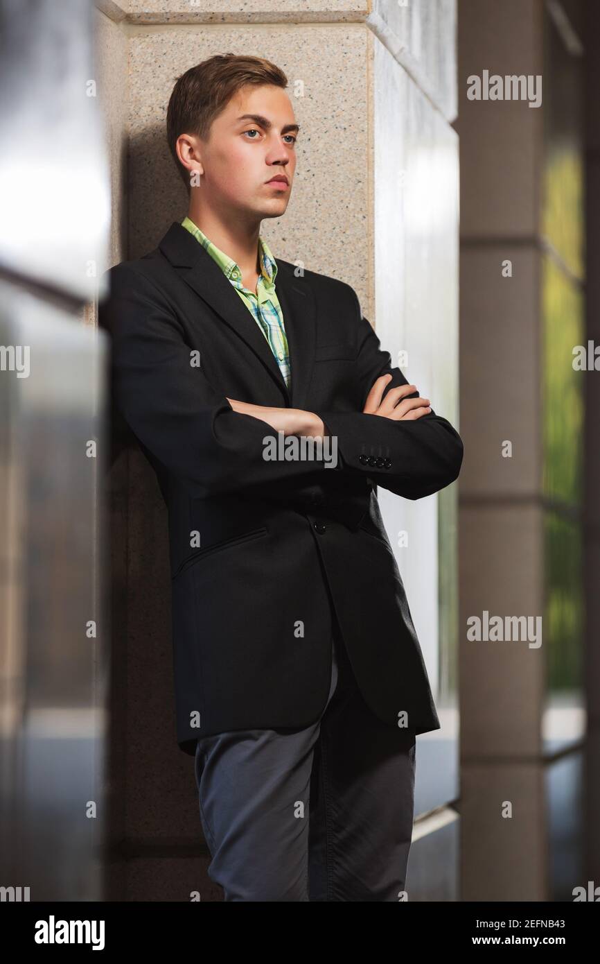 Young handsome business man leaning on the wall Stylish fashion male ...