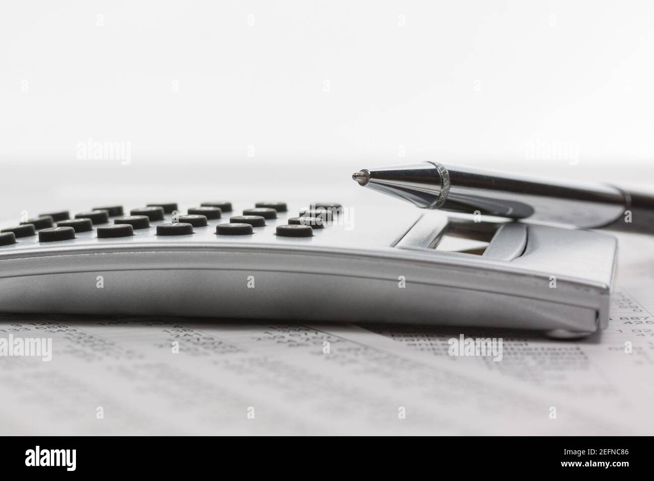 Financial accounting Pen and calculator on balance sheets Stock Photo ...