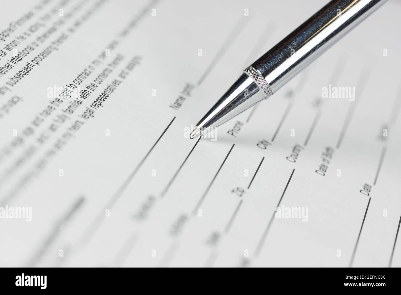 Signing contract pen over form Stock Photo - Alamy