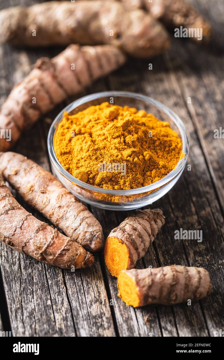 Indian turmeric powder and root. Turmeric spice. Ground turmeric in ...