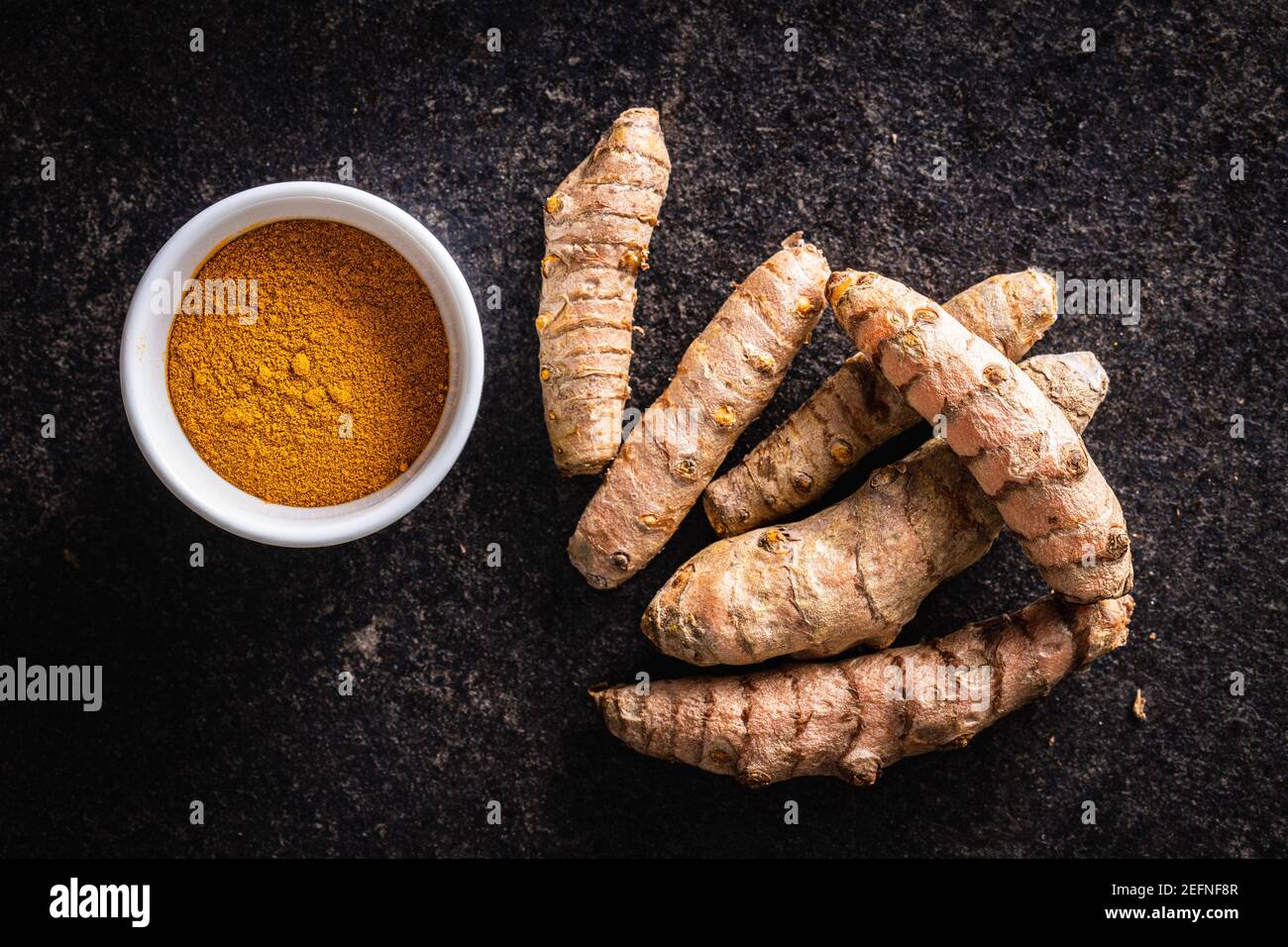 Indian turmeric powder and root. Turmeric spice. Ground turmeric in ...