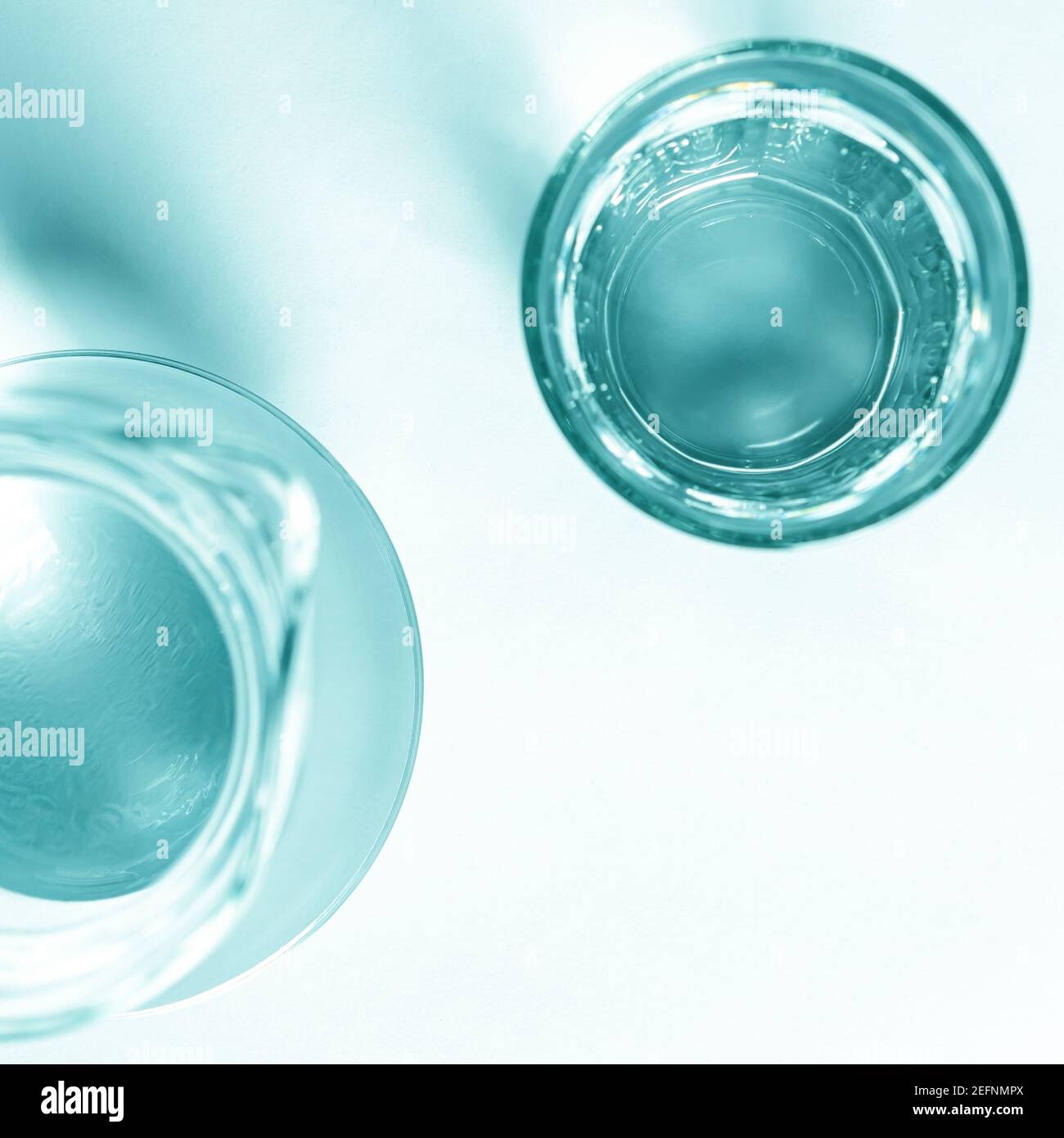 Pure clear water in a glass and jug stands on a white background ...