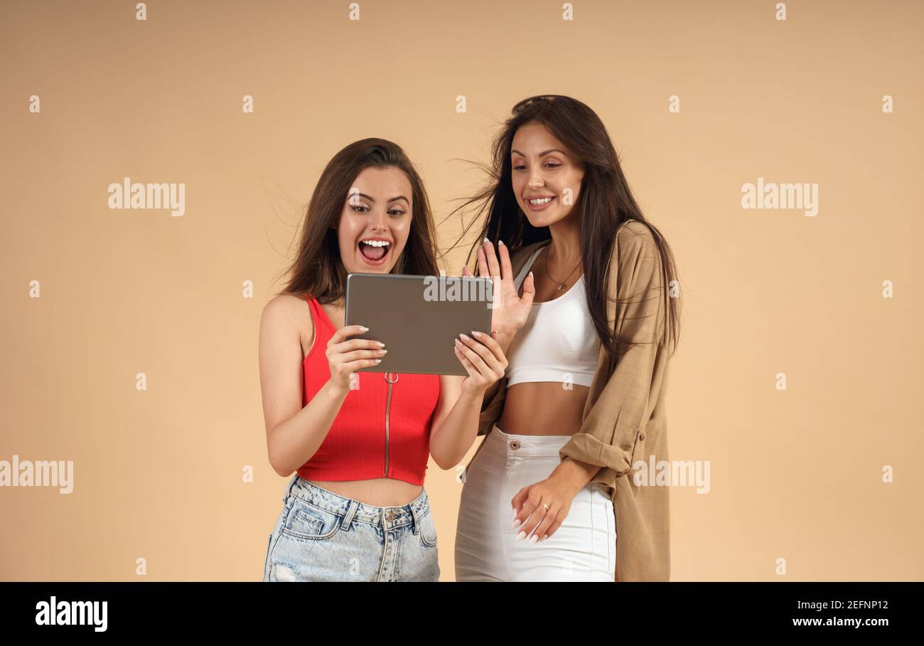 Two cheerful women waving on video call Stock Photo - Alamy