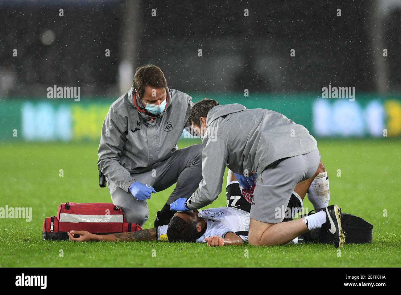 Swansea, UK. 17th Feb, 2021. Kyle Naughton #26 of Swansea City receives ...