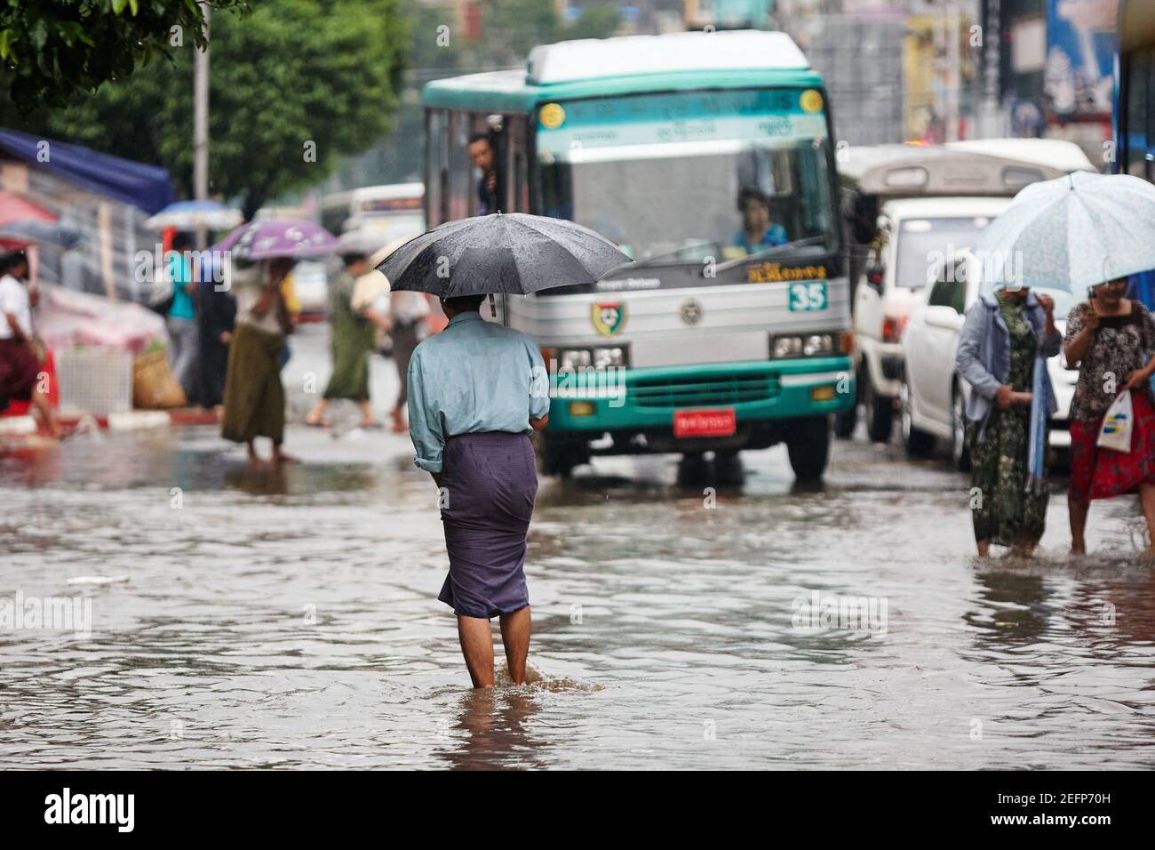 A flooded street in Yangon, Myanmar during a rain storm Stock Photo - Alamy