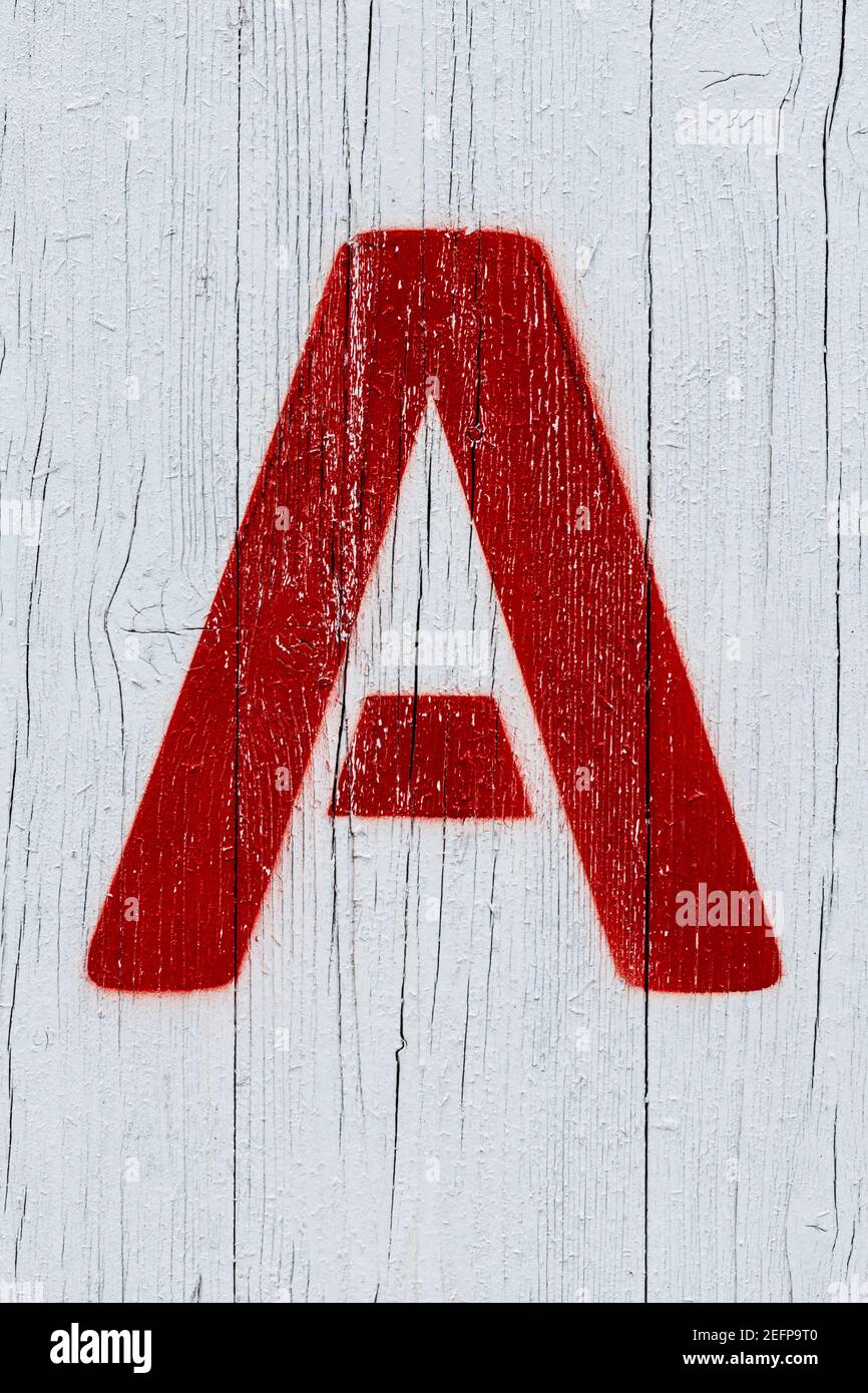 Red letter A sprayed on white painted boards Stock Photo - Alamy