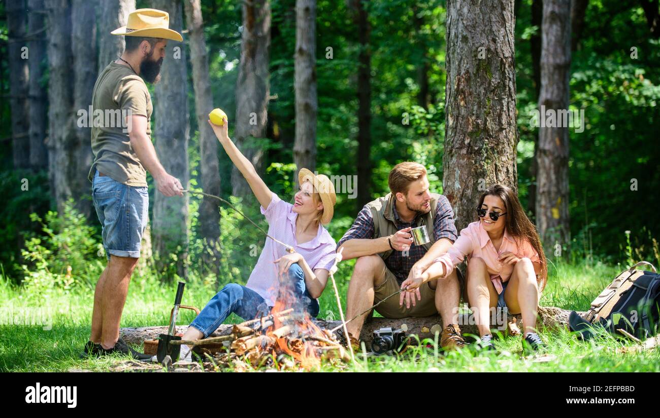 Camping and hiking. Company friends relaxing and having snack picnic ...