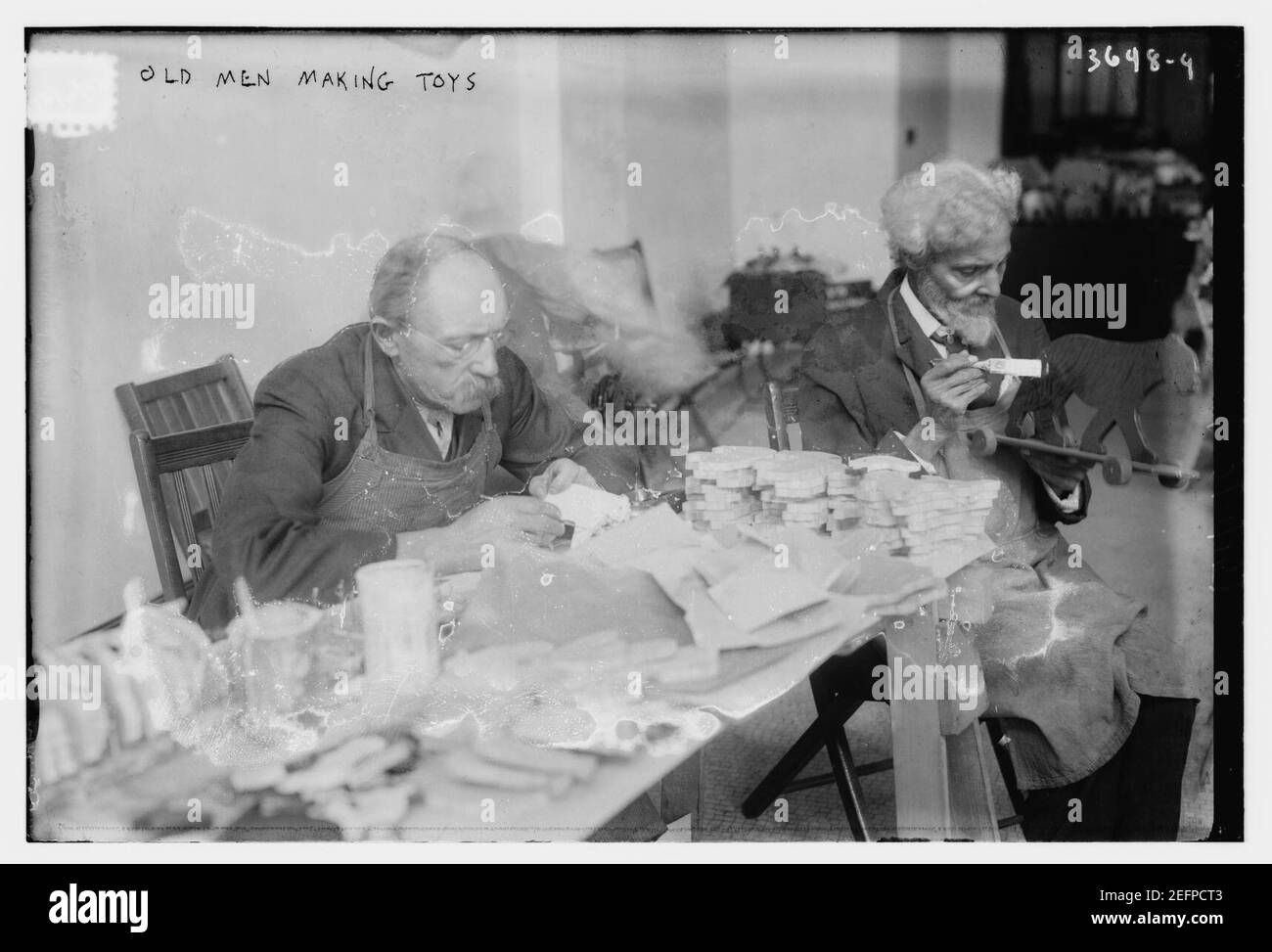 Old Men making toys Stock Photo - Alamy