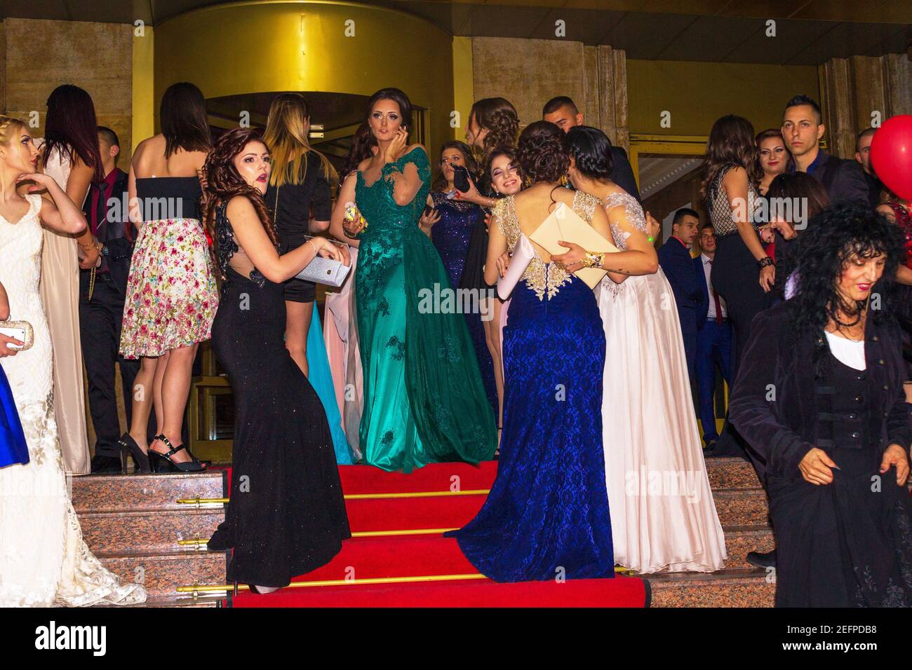 Gorgeous young people school leavers dressed in elegant ballgown and ...