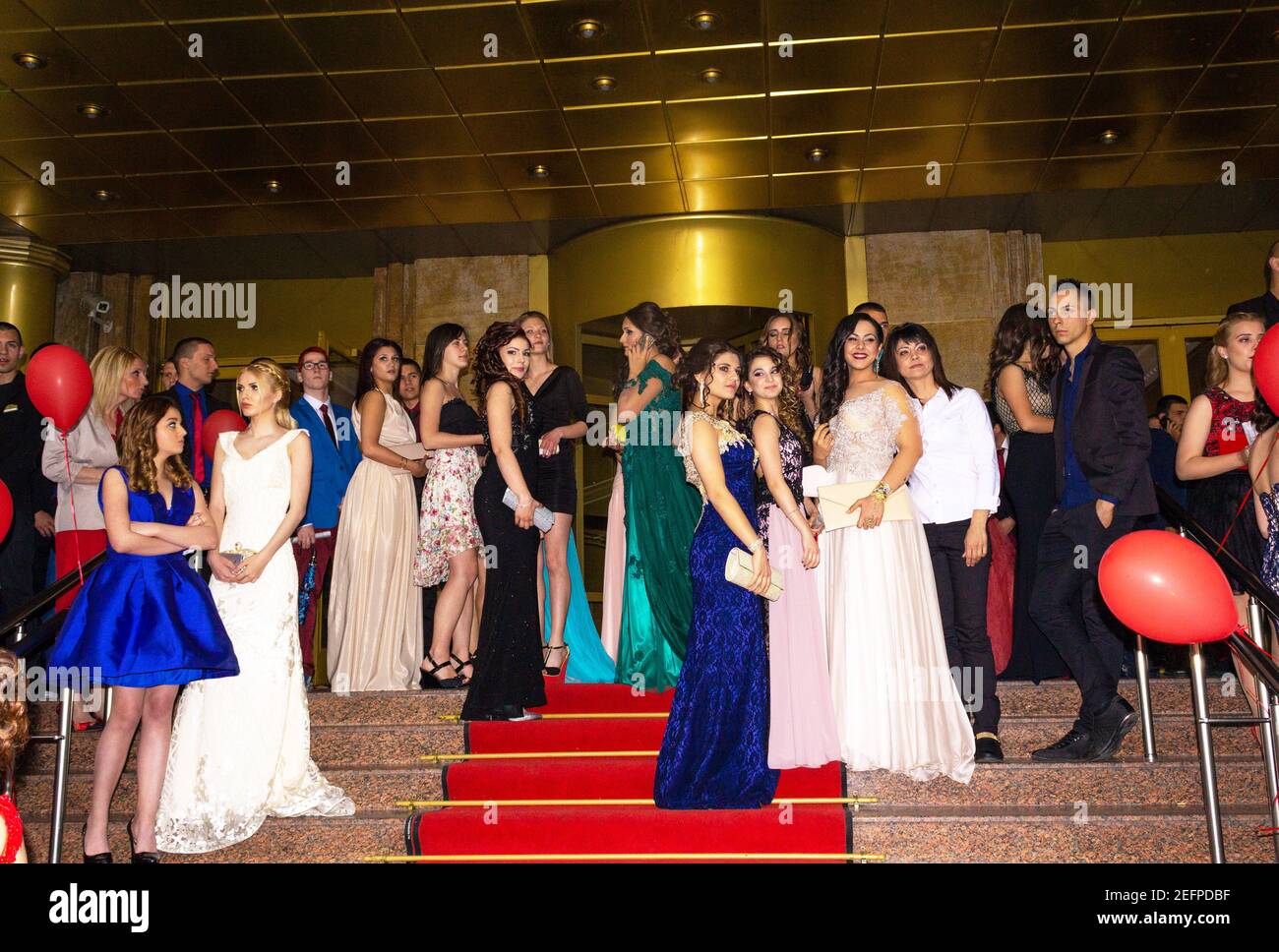 Gorgeous young people school leavers dressed in elegant ballgown and ...