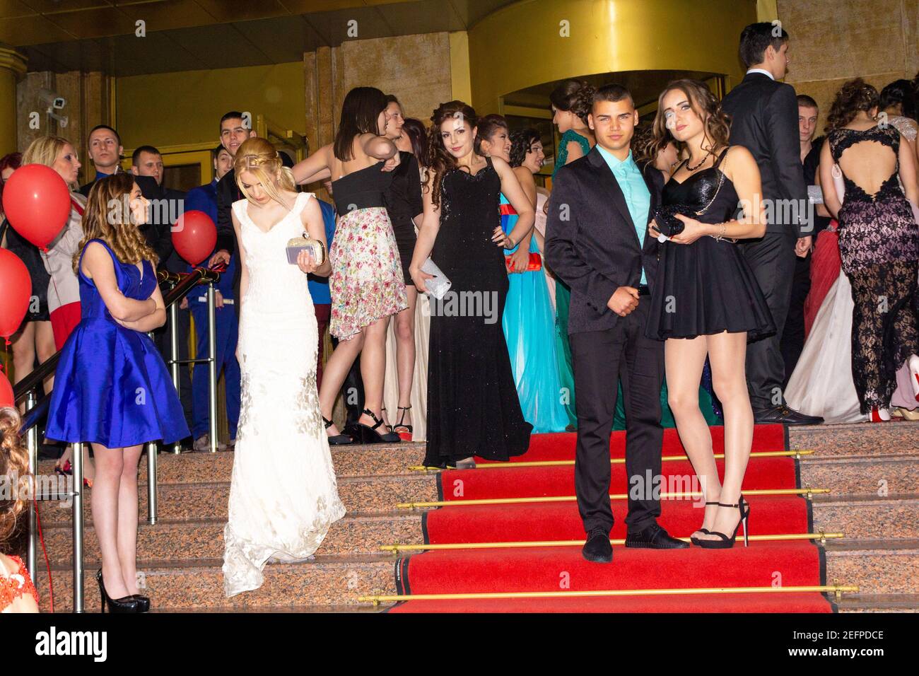 Gorgeous young people school leavers dressed in elegant ballgown and ...