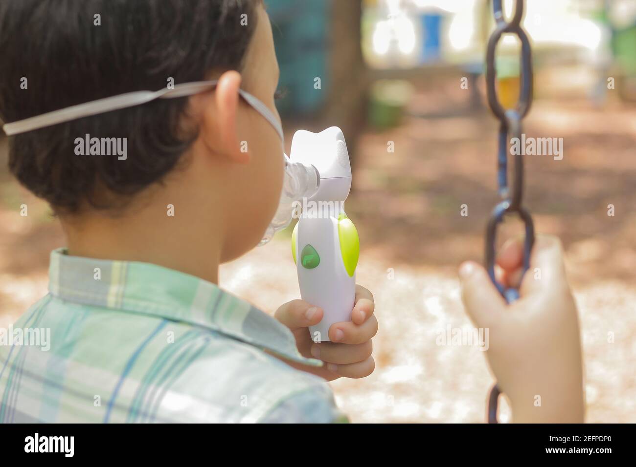 Closeup shot of a male child using a portable inhaler nebulizer Stock ...