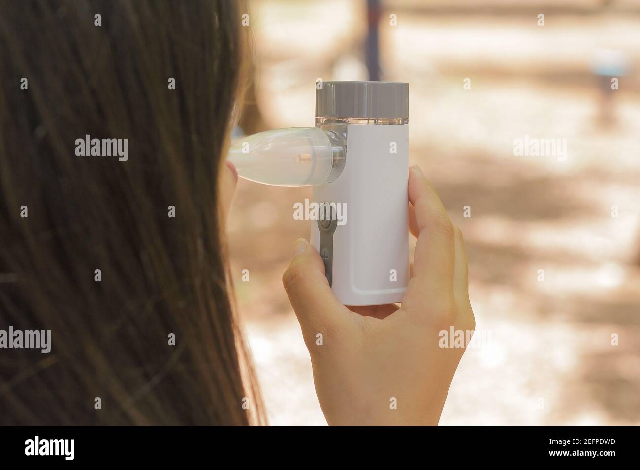 Female using a portable inhaler nebulizer Stock Photo - Alamy