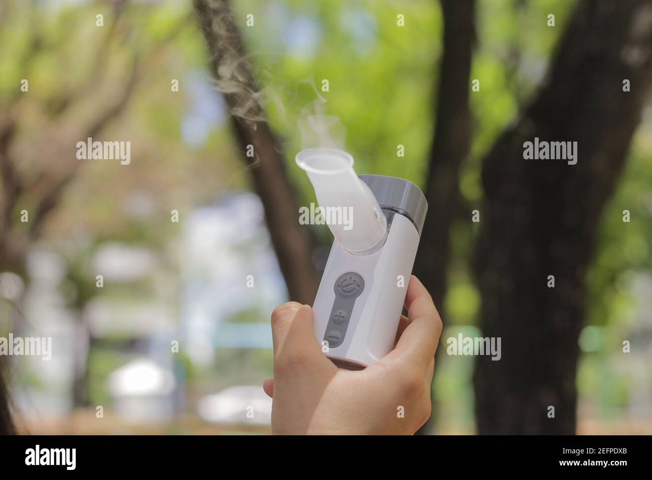 White smoke coming out of a portable inhaler nebulizer Stock Photo - Alamy