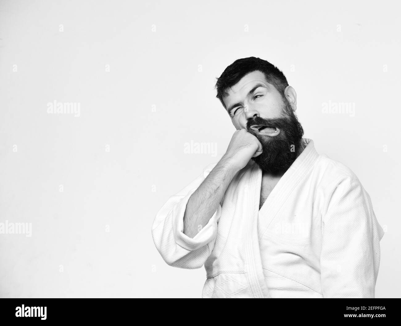 Karate man with suffering face in uniform. Japanese martial arts ...