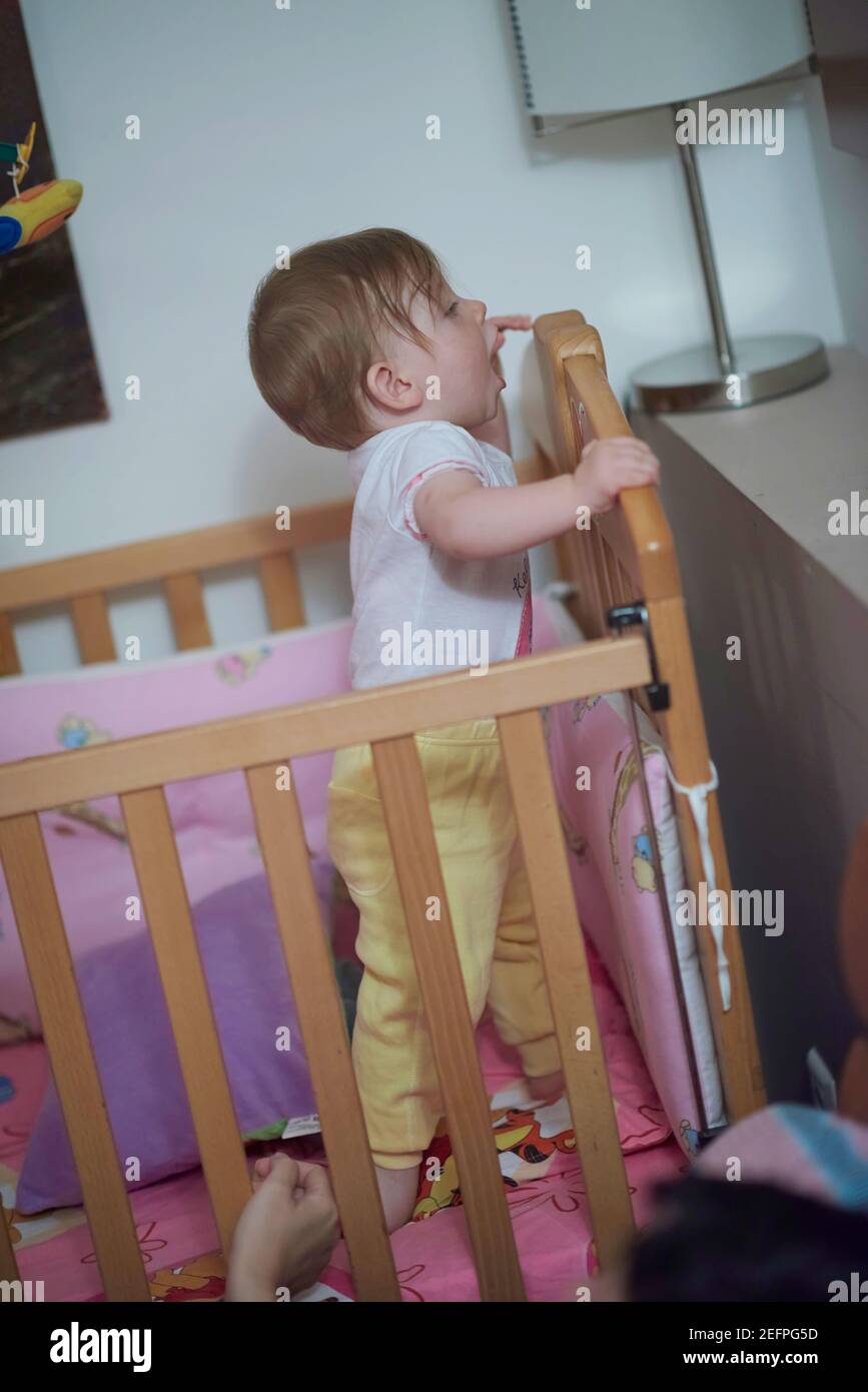 cute little one year old baby and making first steps in bed Stock Photo ...