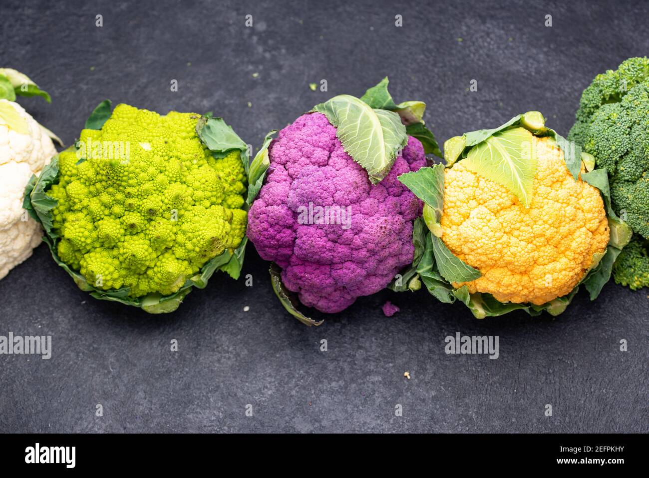 Purple, yellow, white and green color cauliflowers Stock Photo - Alamy