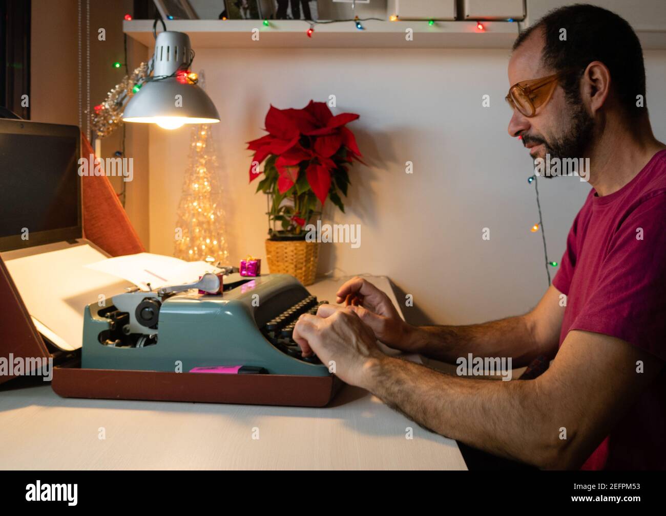 Soft focus of an old fashioned Caucasian writer typing on a typewriter ...