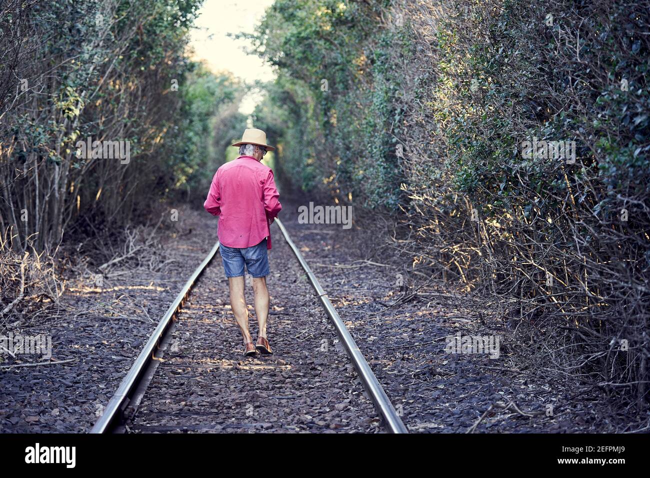 View Of Man Walking On Train Tracks.View Of Man Standing At Entrance Of ...