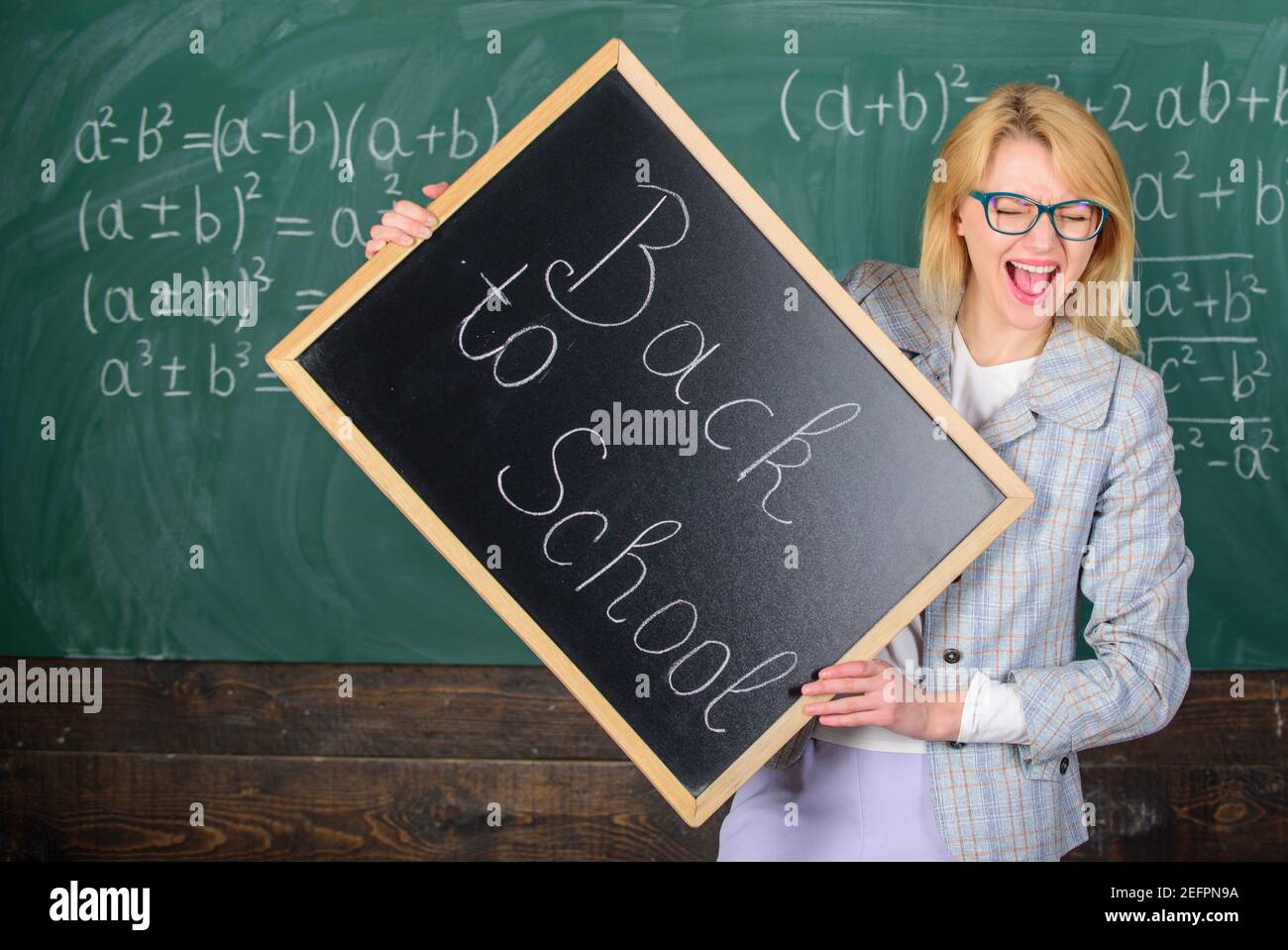 Woman teacher holds blackboard inscription back to school. Hiring ...